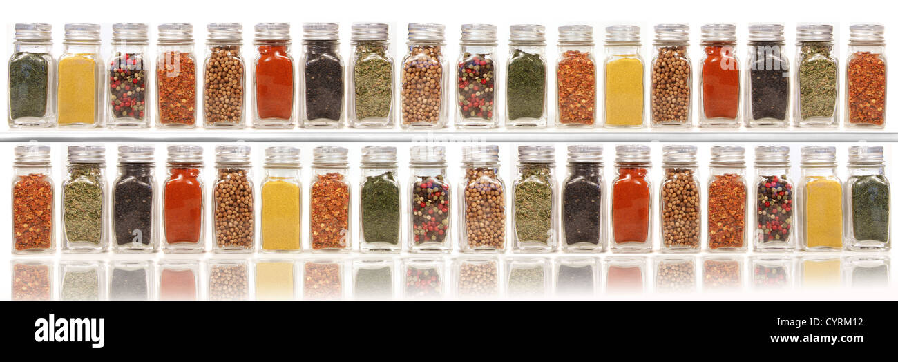 Assorted spices on two layer shelves against white background Stock ...