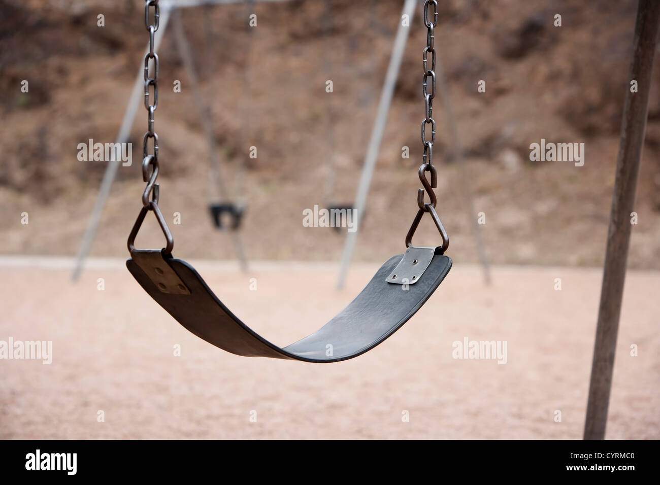 Old style playground swing with chains and rubber seat Stock Photo - Alamy