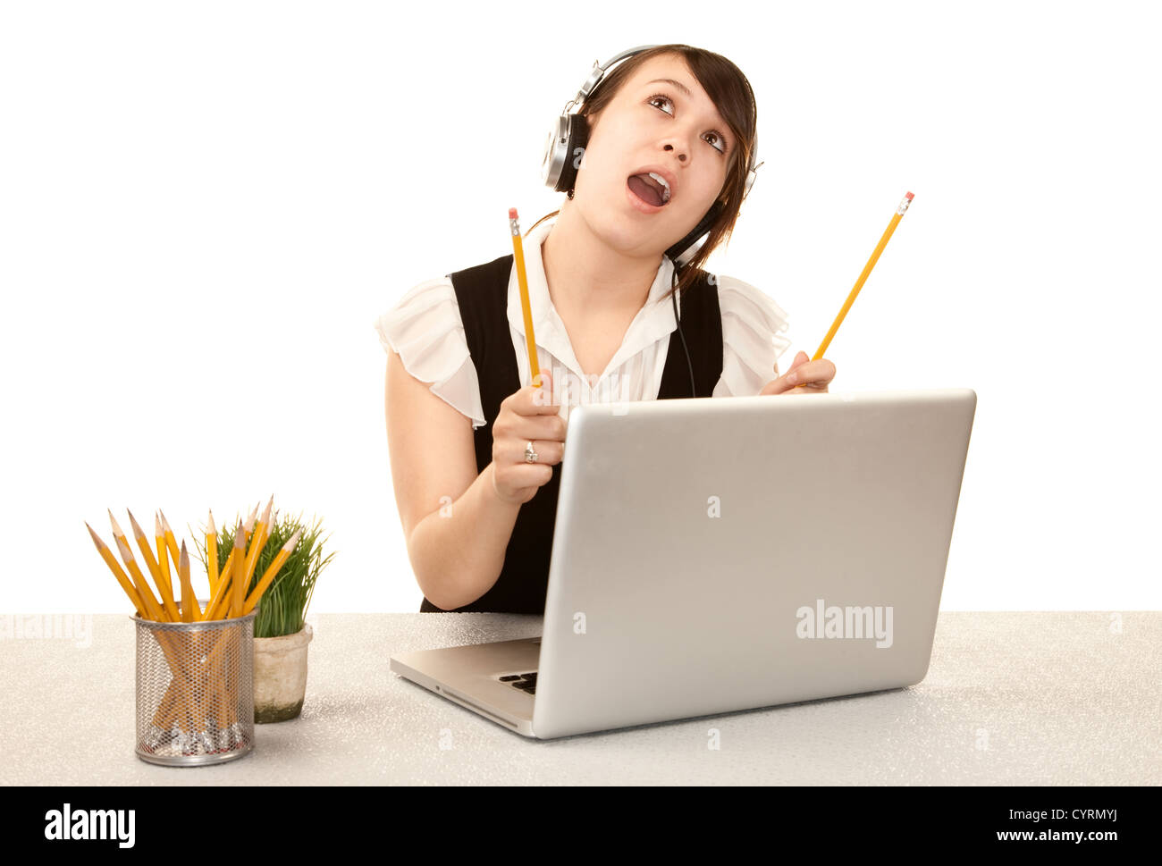 Pretty female office worker with laptop computer and headphones Stock ...