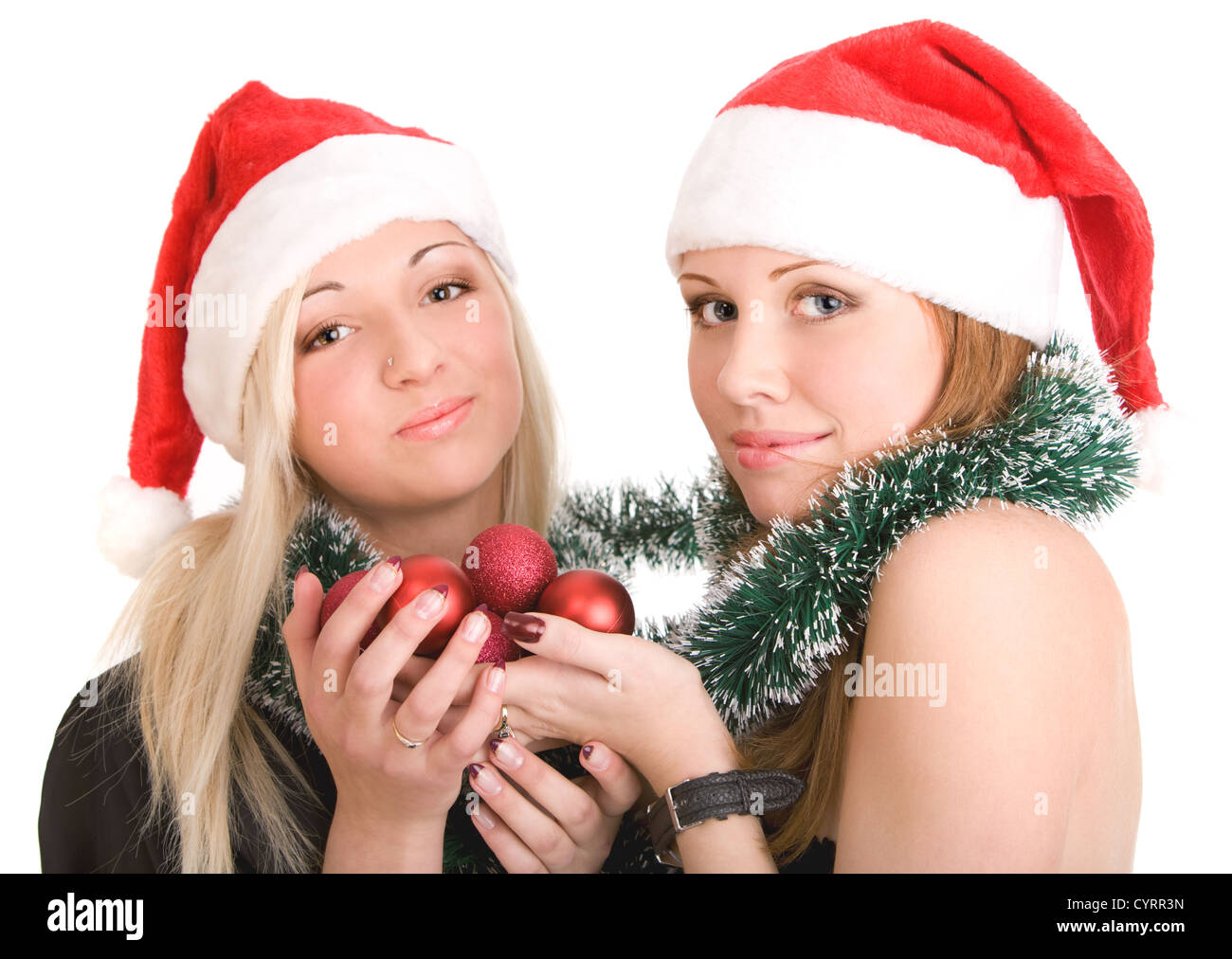 Two girls in Santa hats on isolated white Stock Photo - Alamy