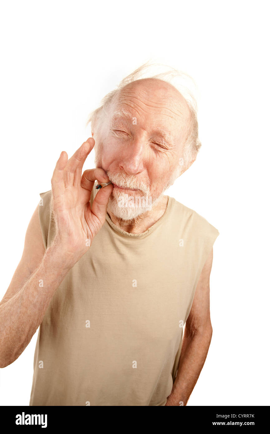 Senior man in ragged shirt smoking cigarette stub or marijuana reefer ...