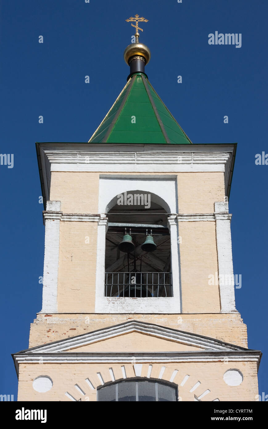 The top of bell tower over sky-blue background Stock Photo - Alamy