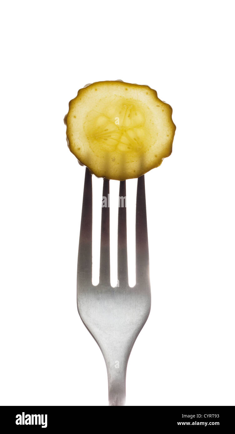 A fresh dill pickle on a fork isolated over white Stock Photo - Alamy