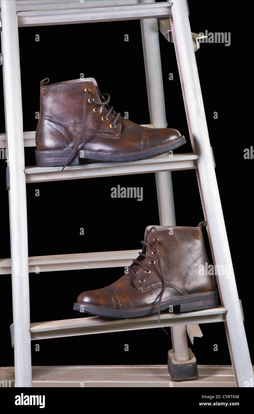Close-up of leather boots on a step ladder Stock Photo - Alamy