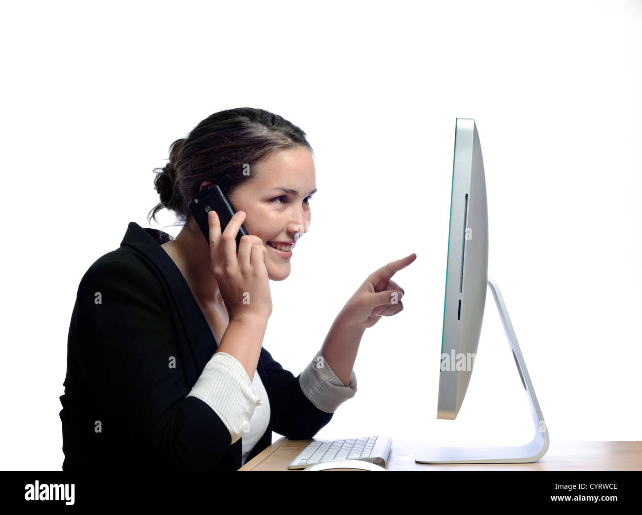 Office worker talks on her mobile whone while at her desk Stock Photo ...