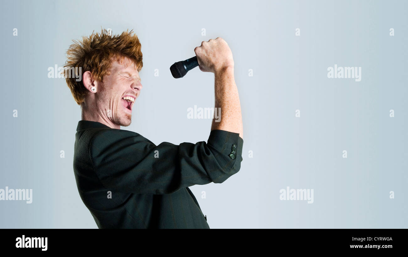 Super rock star lead singer belts out a high note Stock Photo - Alamy