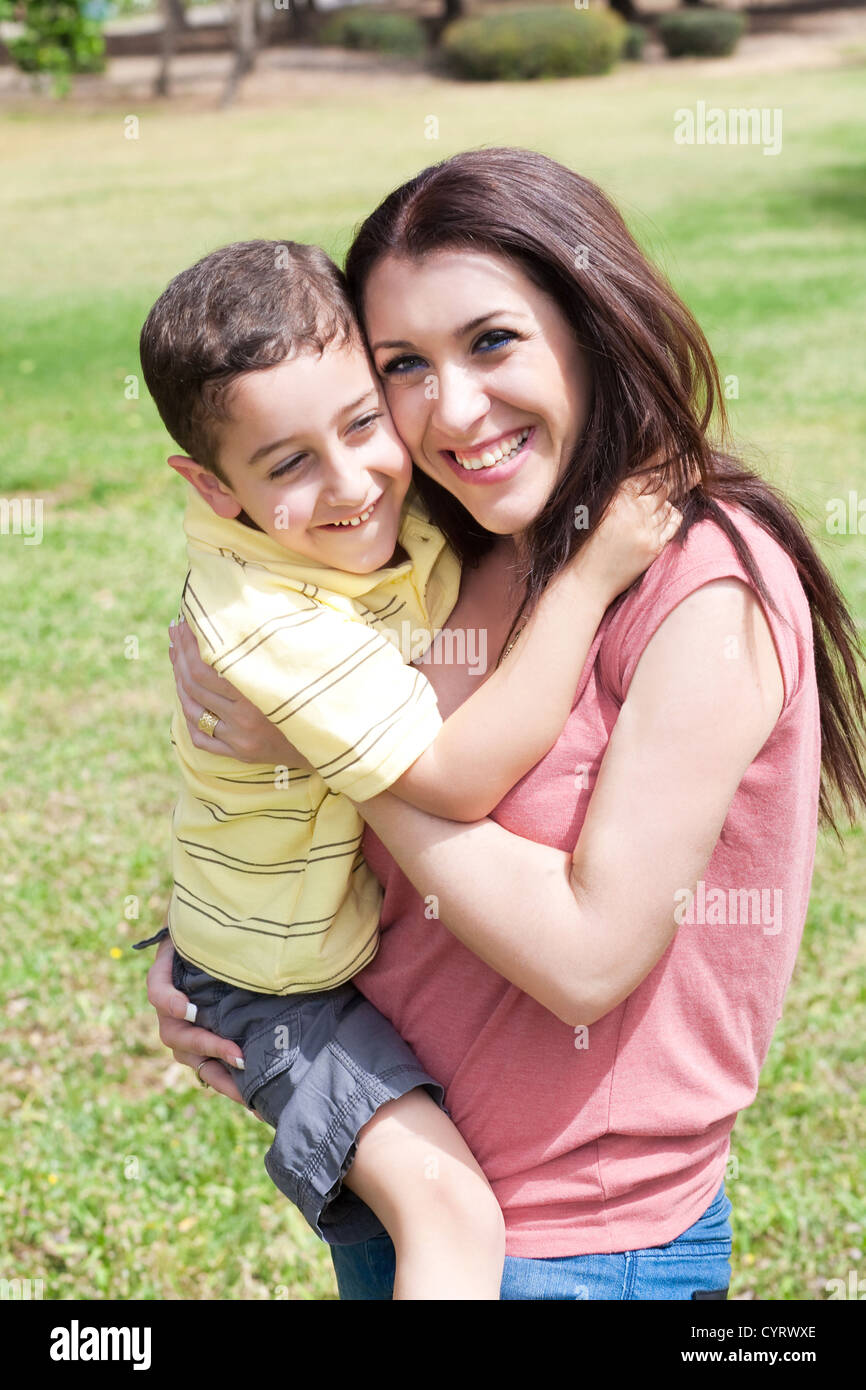 Cute kid hug is mom in the park, outdoor Stock Photo - Alamy