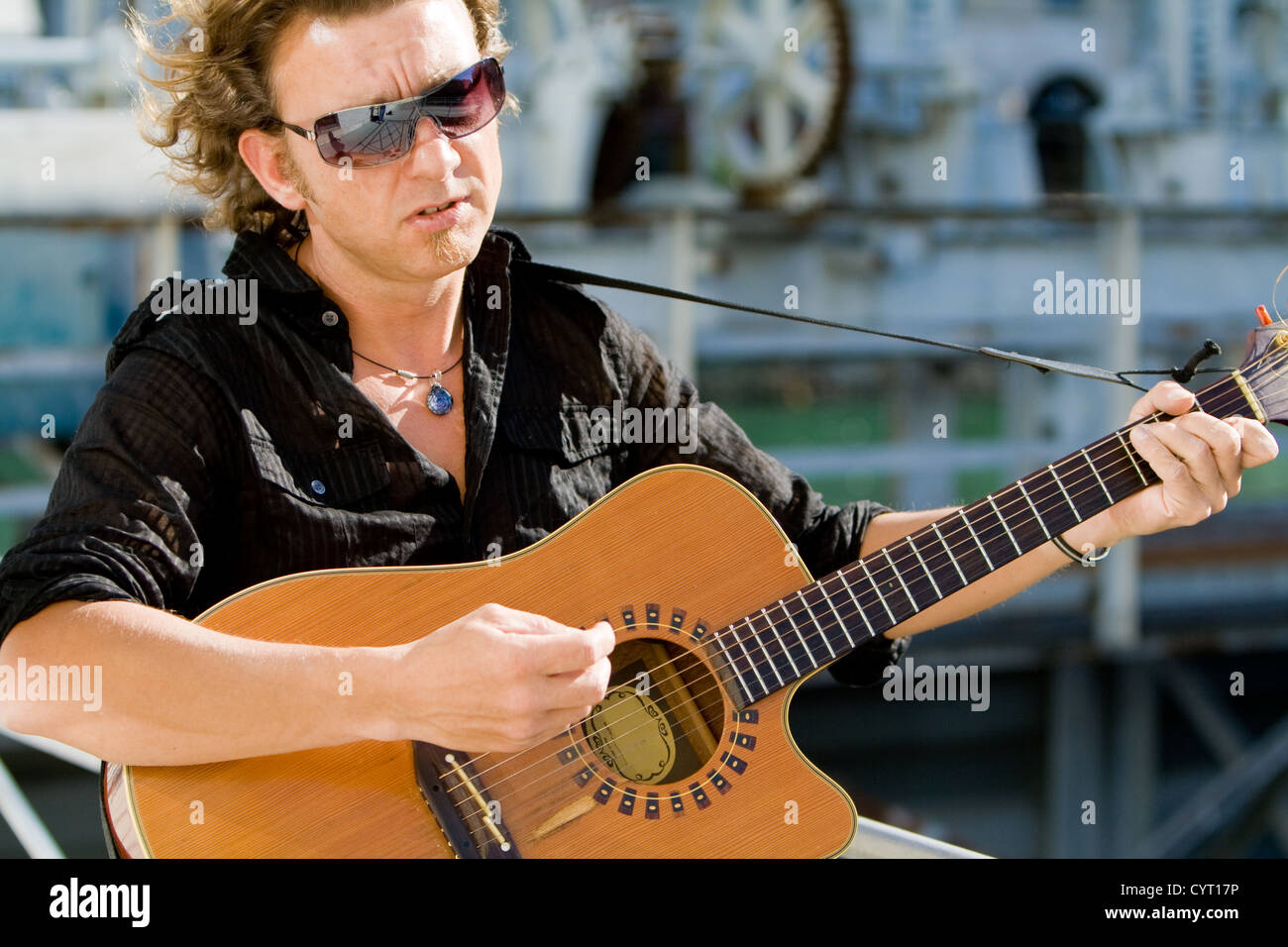Rock star with acoustic guitar performing live in the summer Stock ...
