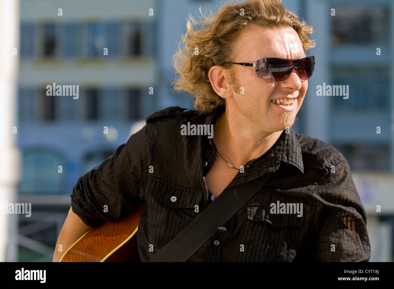 Rock star with acoustic guitar performing live in the summer Stock ...