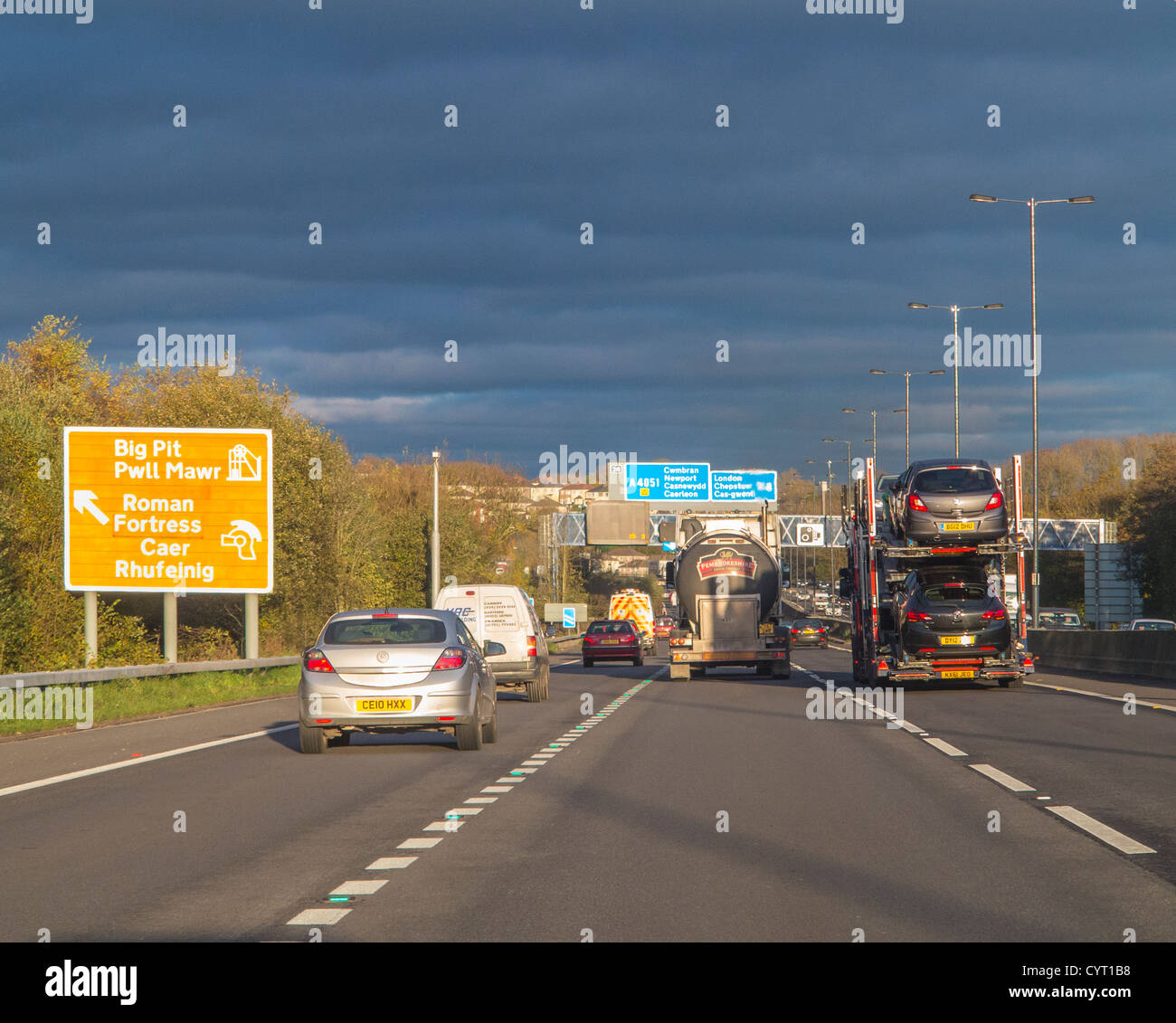 M4 motorway with cars and lorries in Wales with overhead gantry showing ...