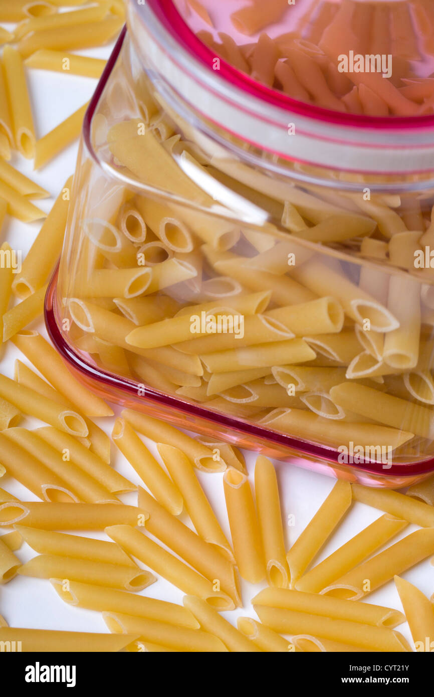 Pasta in glass pot isolated on white background Stock Photo - Alamy