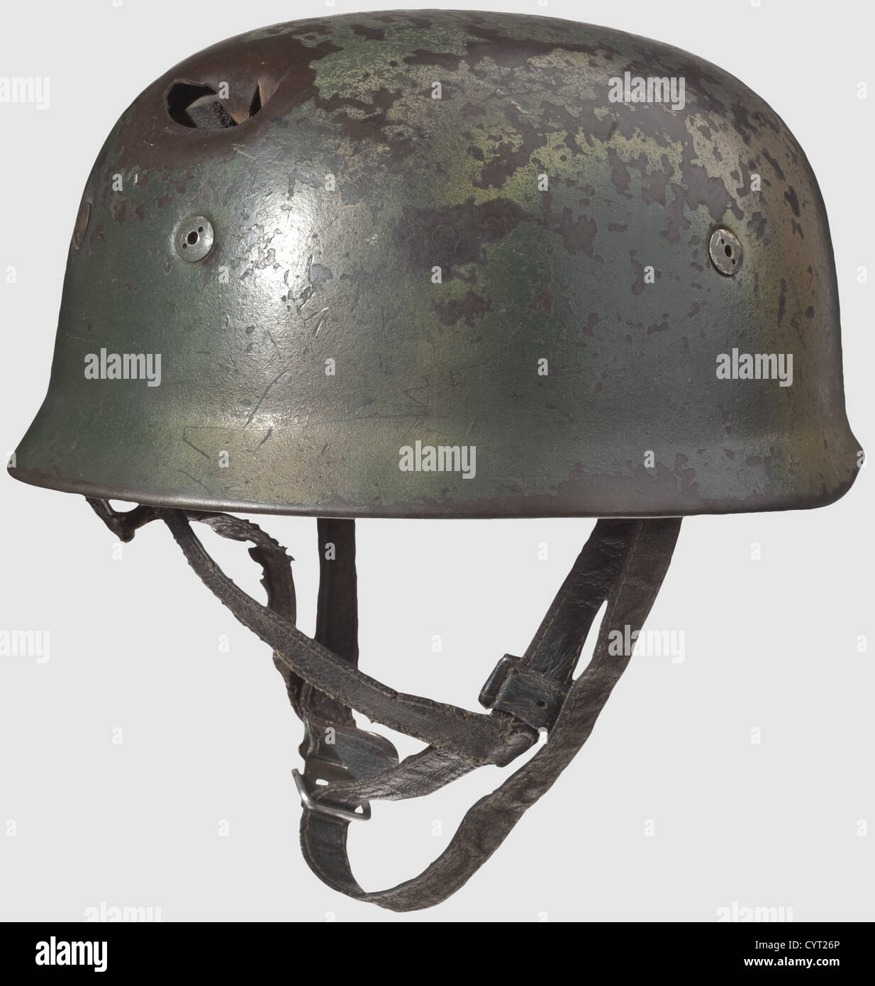 A paratrooperïs steel helmet,camouflage pattern with hole from shell ...