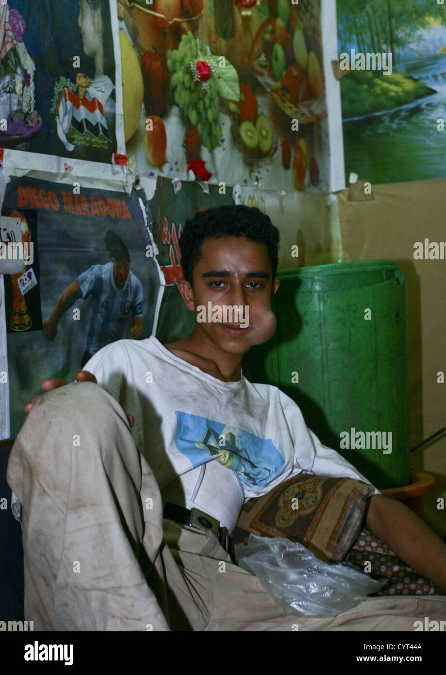 Young Man Lying Down And Chewing Qat In A Room Full Of Posters, Sanaa ...