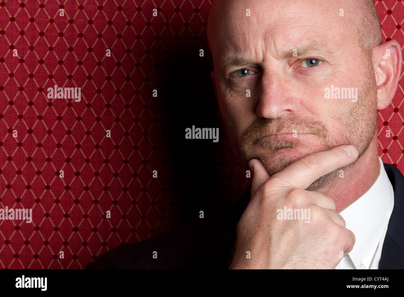 Handsome businessman thinking Stock Photo - Alamy