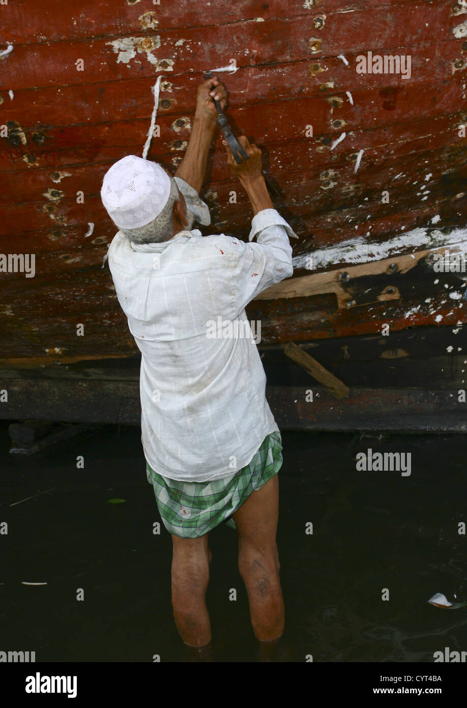 Man Working On The Impermeability Of A Dhow, Al Hodeidah Harbour, Yemen ...