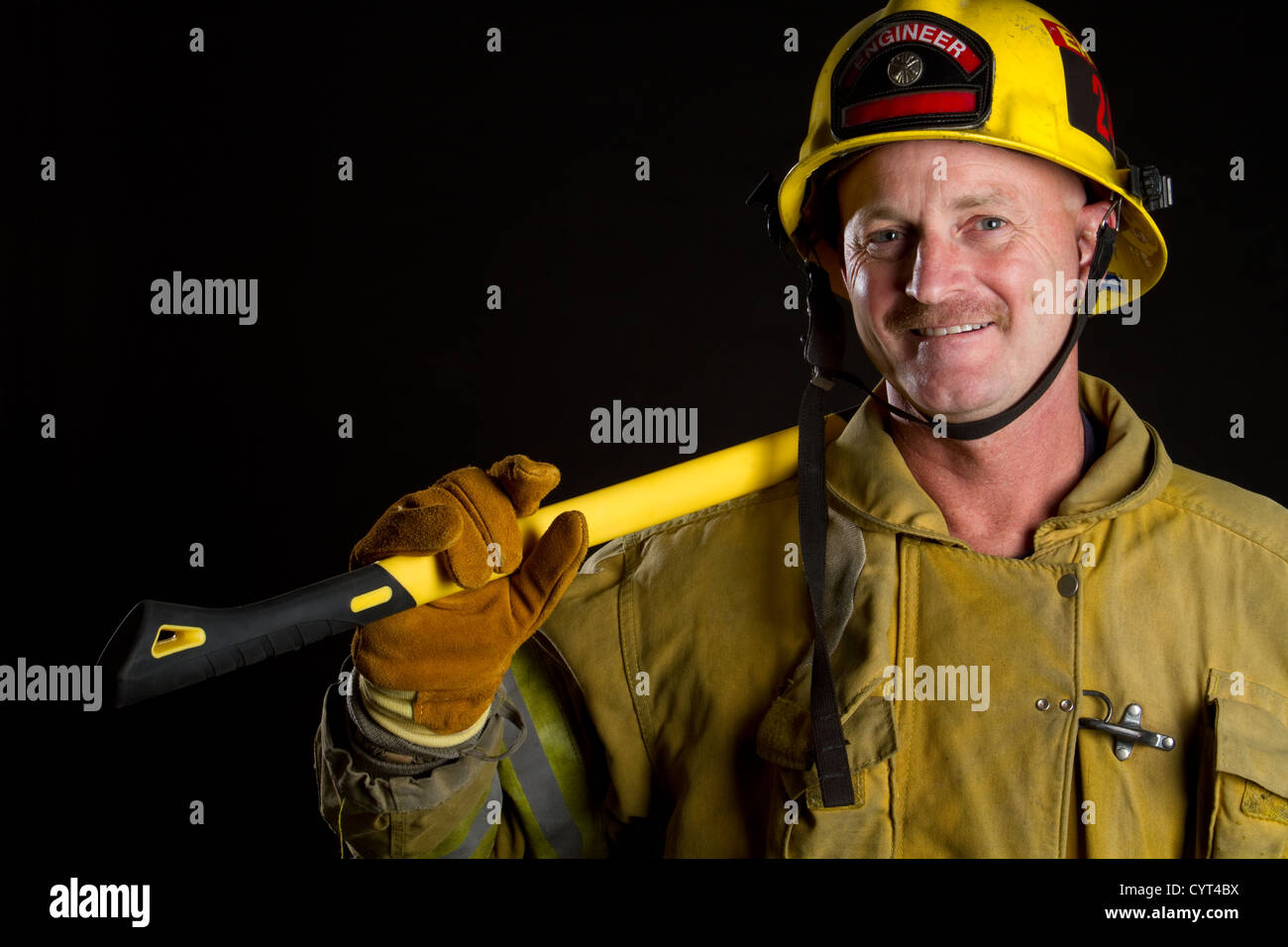 Firefighter holding axe Stock Photo - Alamy