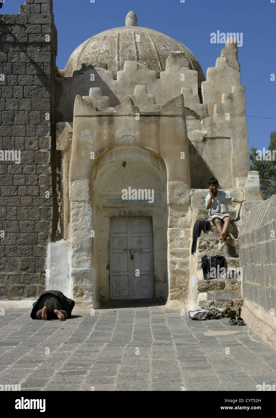 Man Praying And Boy Sitting On Stairs In Dhamar, Yemen Stock Photo - Alamy