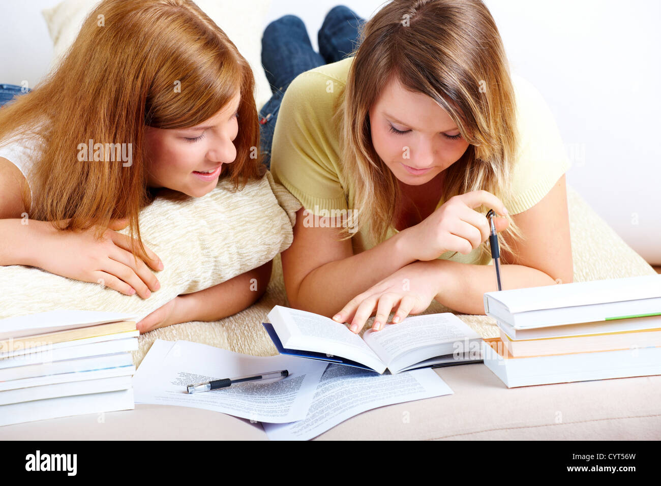 Two cute girls learning with books Stock Photo - Alamy