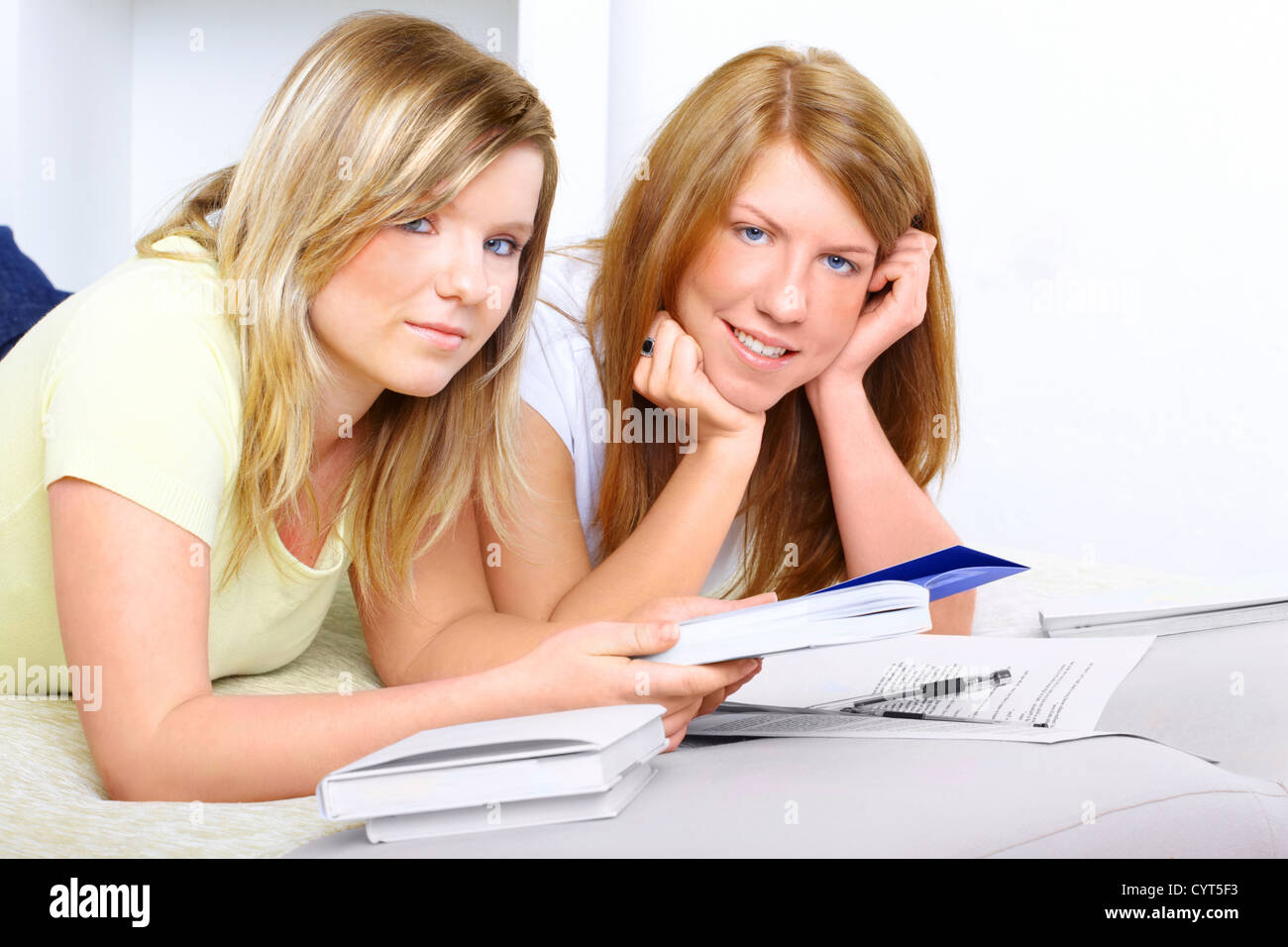 Beautiful girls learning reading from books Stock Photo - Alamy