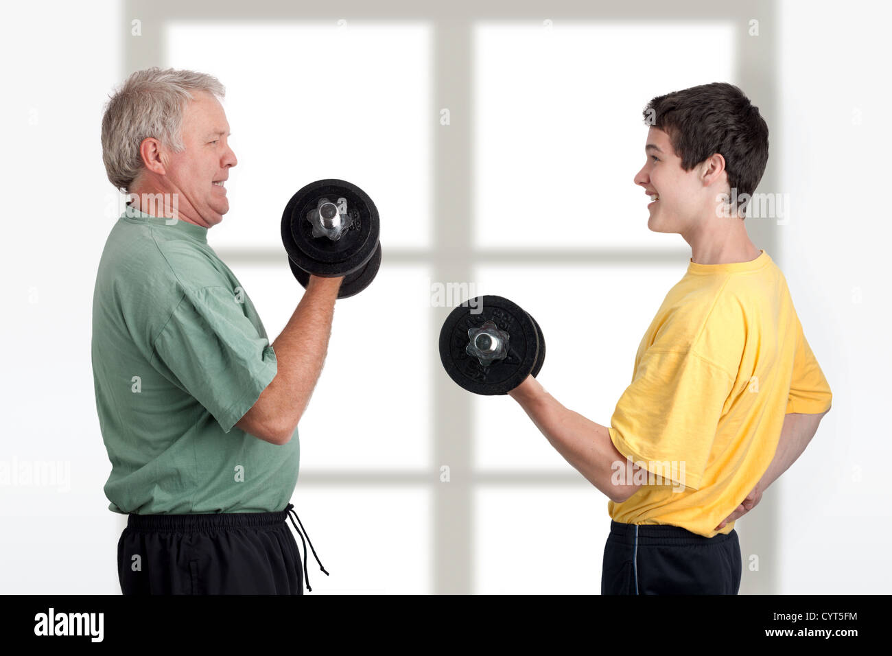 Father and son doing weight lifting together Stock Photo - Alamy