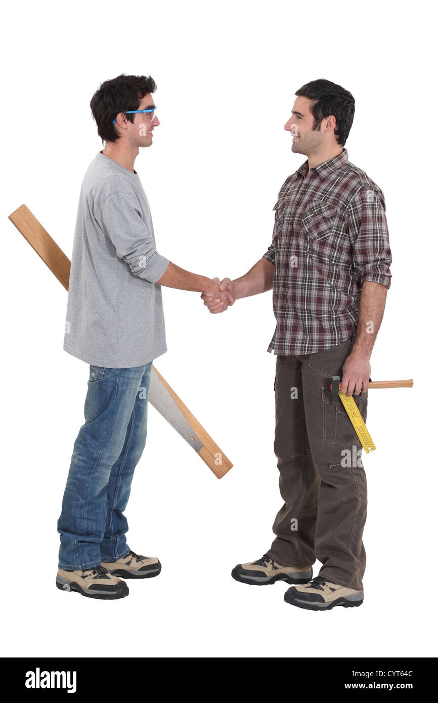 Two carpenters greeting each other Stock Photo - Alamy