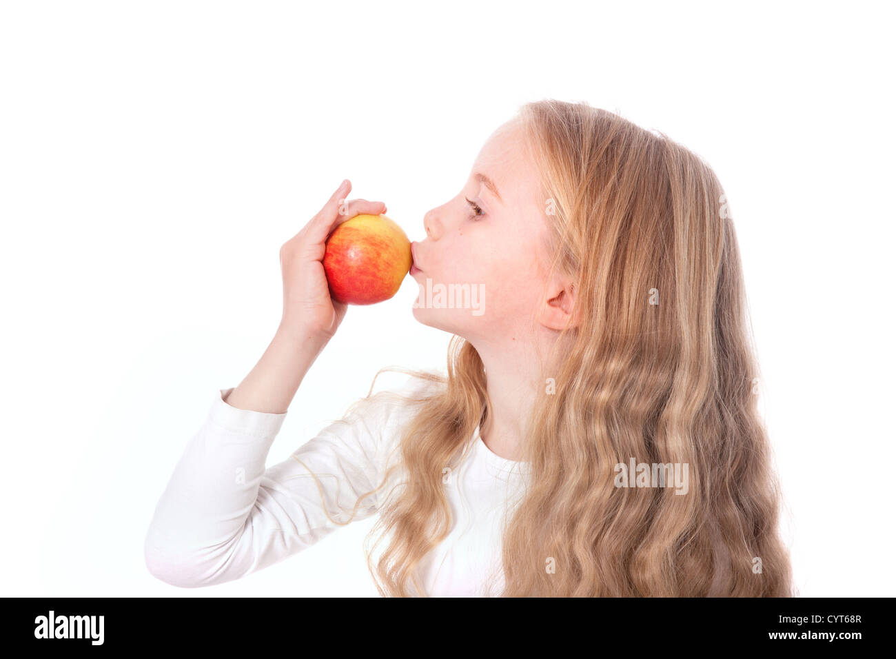 young girl kisses red and yellow apple with white background Stock ...