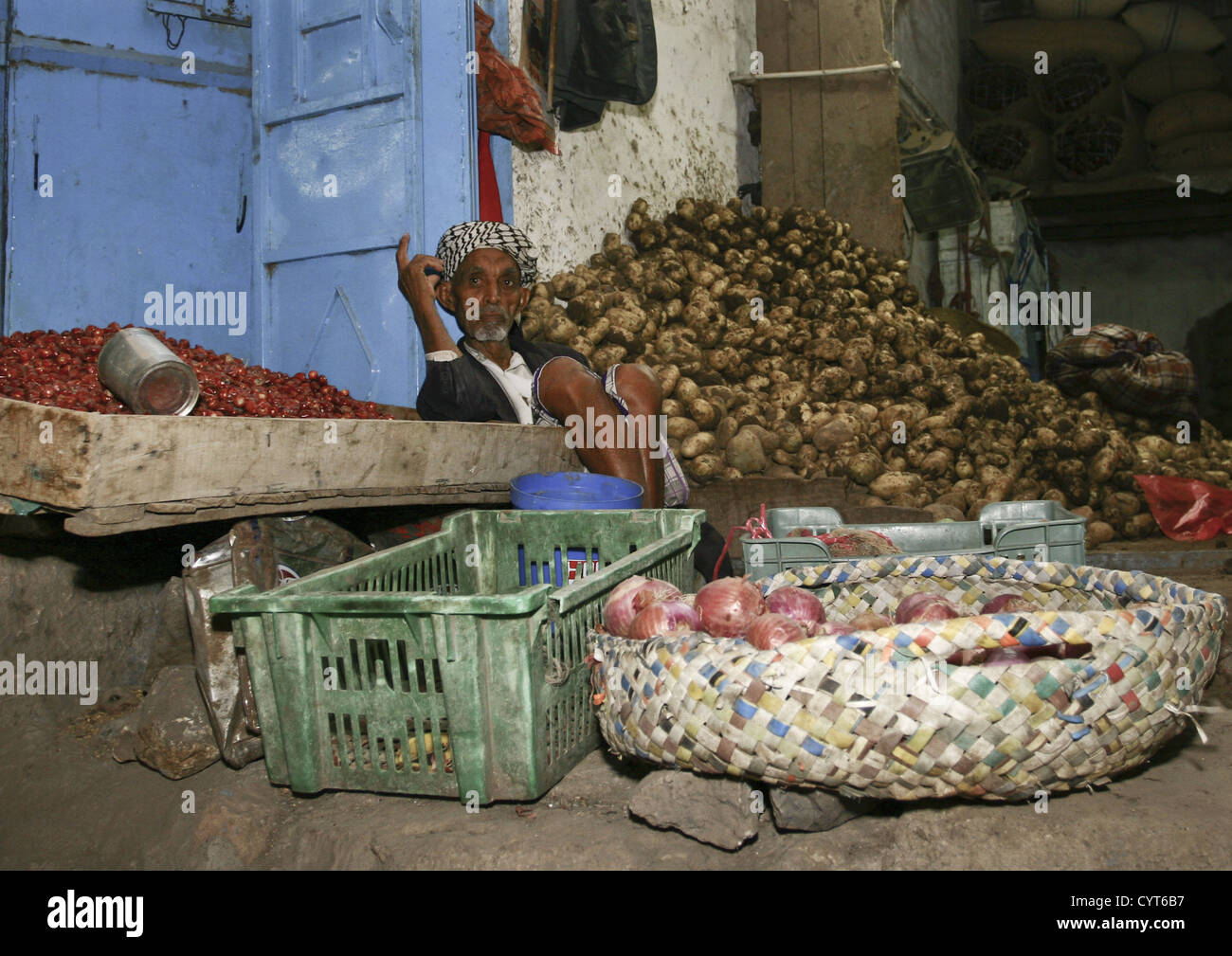 Seller Sitting On The Ground Among His Goods At Al Hodeidah Souq, Yemen ...