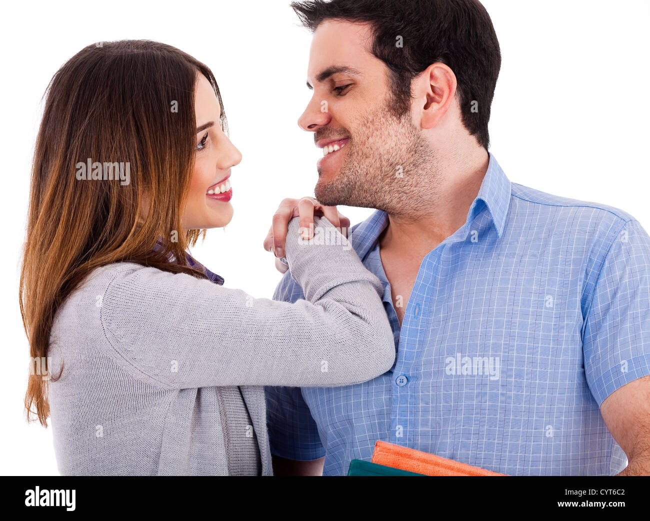 Beautiful couple smiling and facing each other on a isolated white ...
