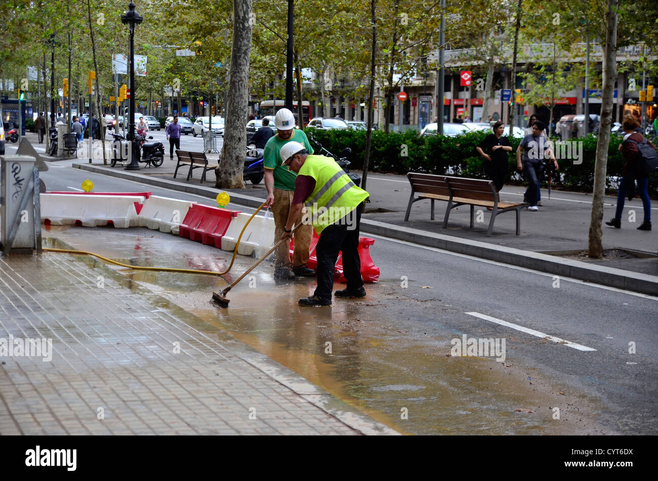 Workers cleaning the street with water Stock Photo - Alamy