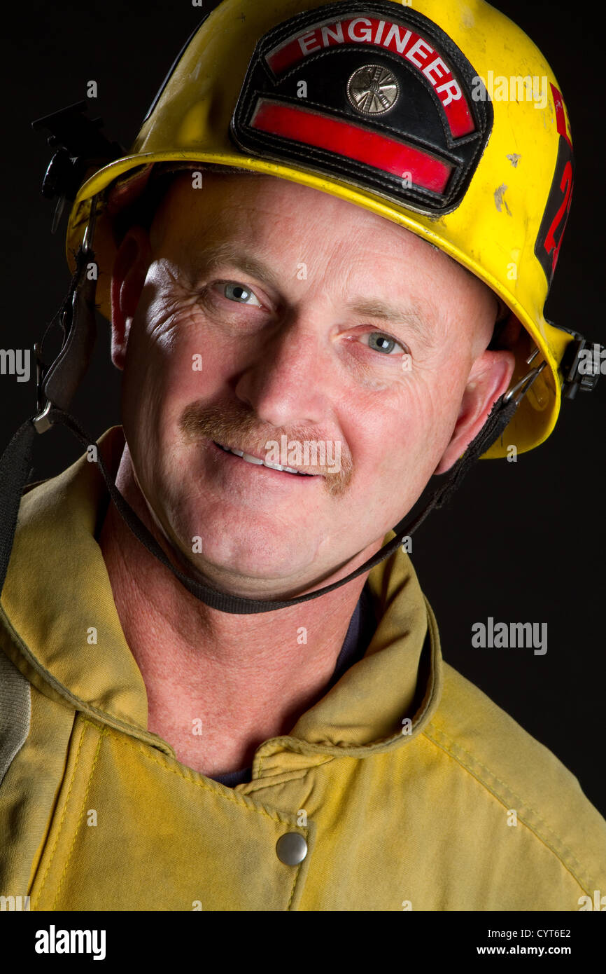 Smiling fireman wearing helmet Stock Photo - Alamy