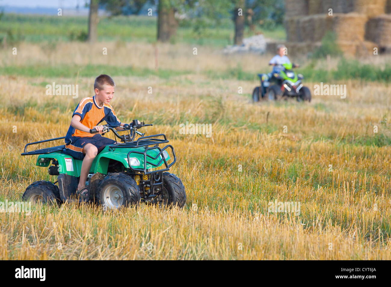 Boy riding a quad bike Stock Photo - Alamy