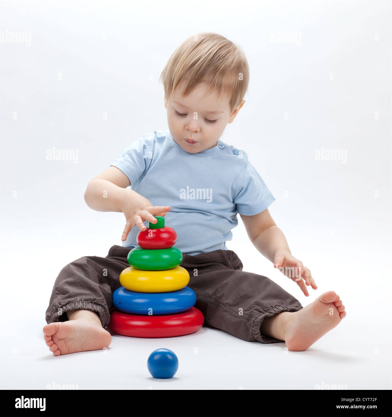 Small baby with a toy pyramid. Isolated on white background Stock Photo ...