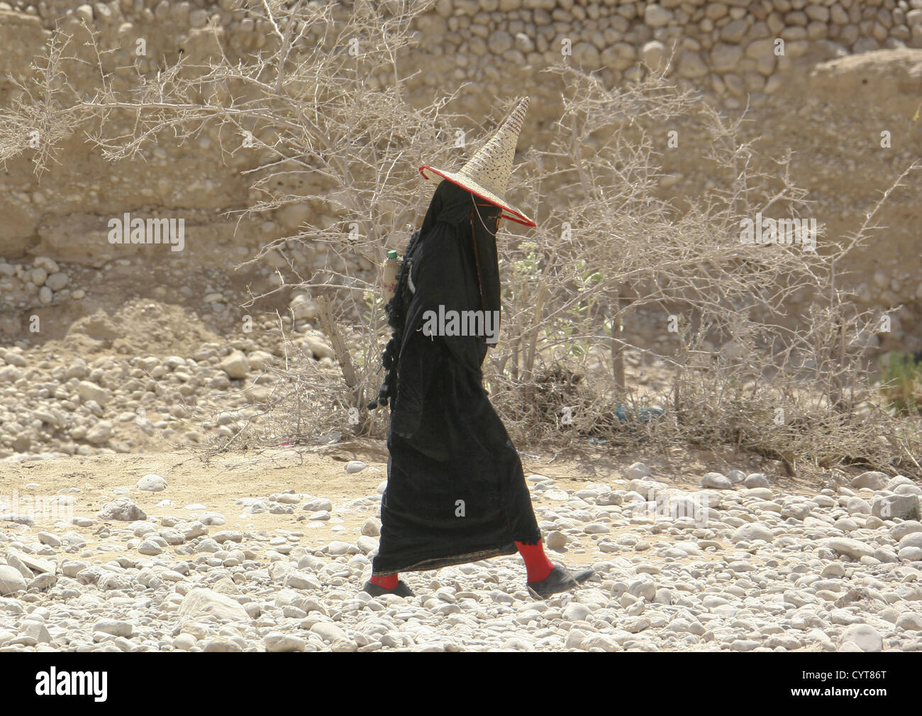 Hadramaut Woman Dressed In Black And Wearing A Cone Hat Passing By ...