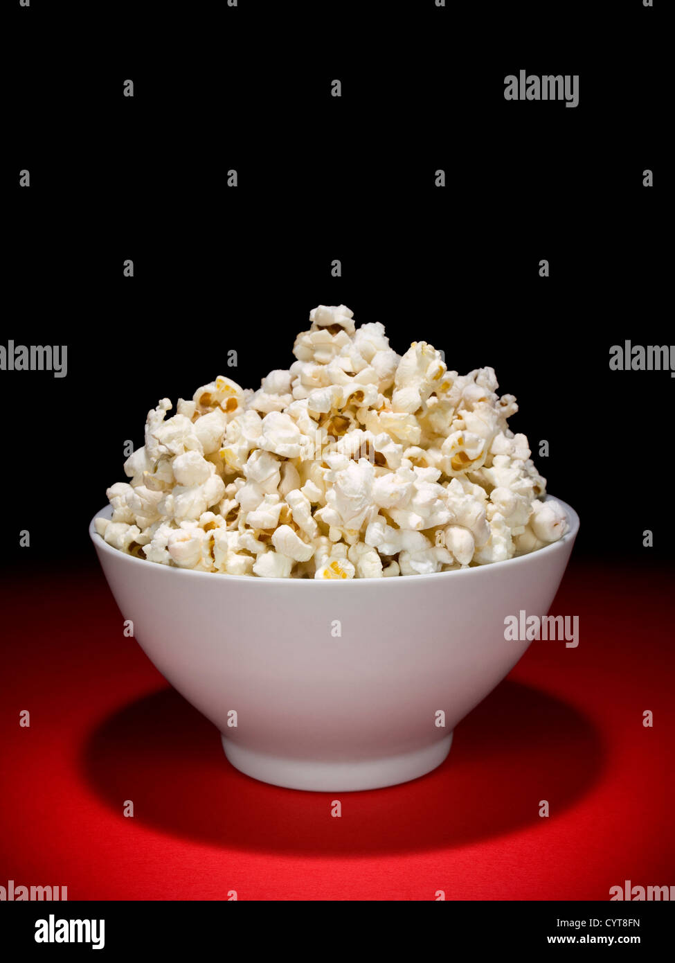 A bowl full of popcorn under the spotlight Stock Photo - Alamy