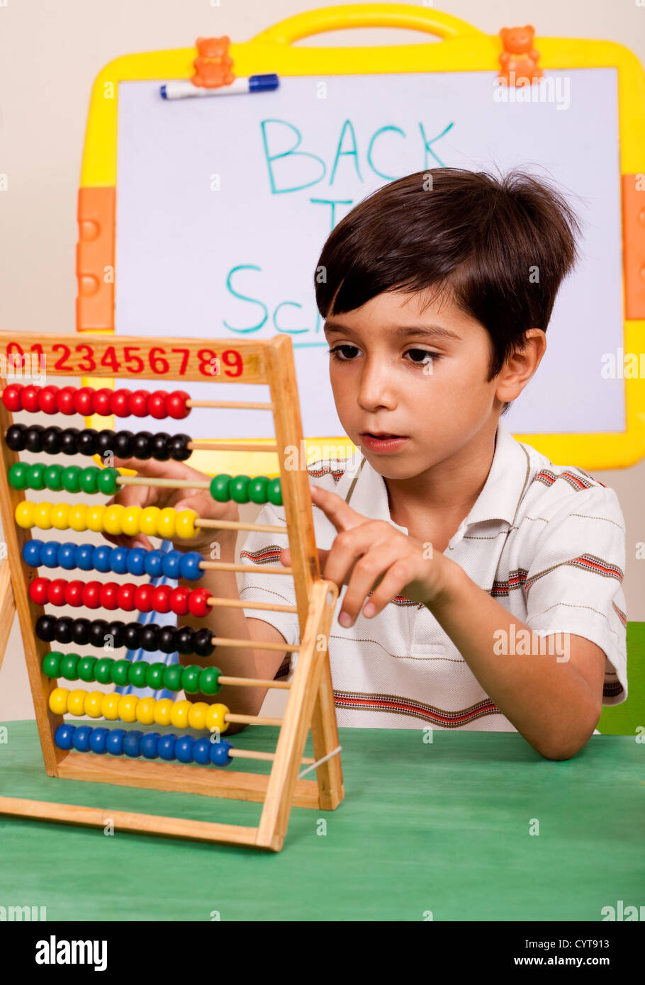 Young boy playing abacus in classroom enviroment Stock Photo - Alamy