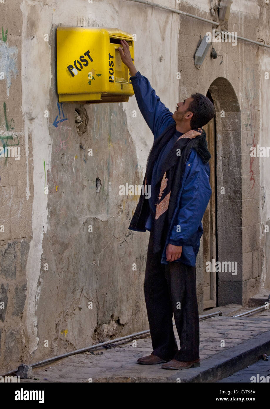 Man Posting Letters In A Strangely Highly Placed Yellow Mailbox, Sanaa ...