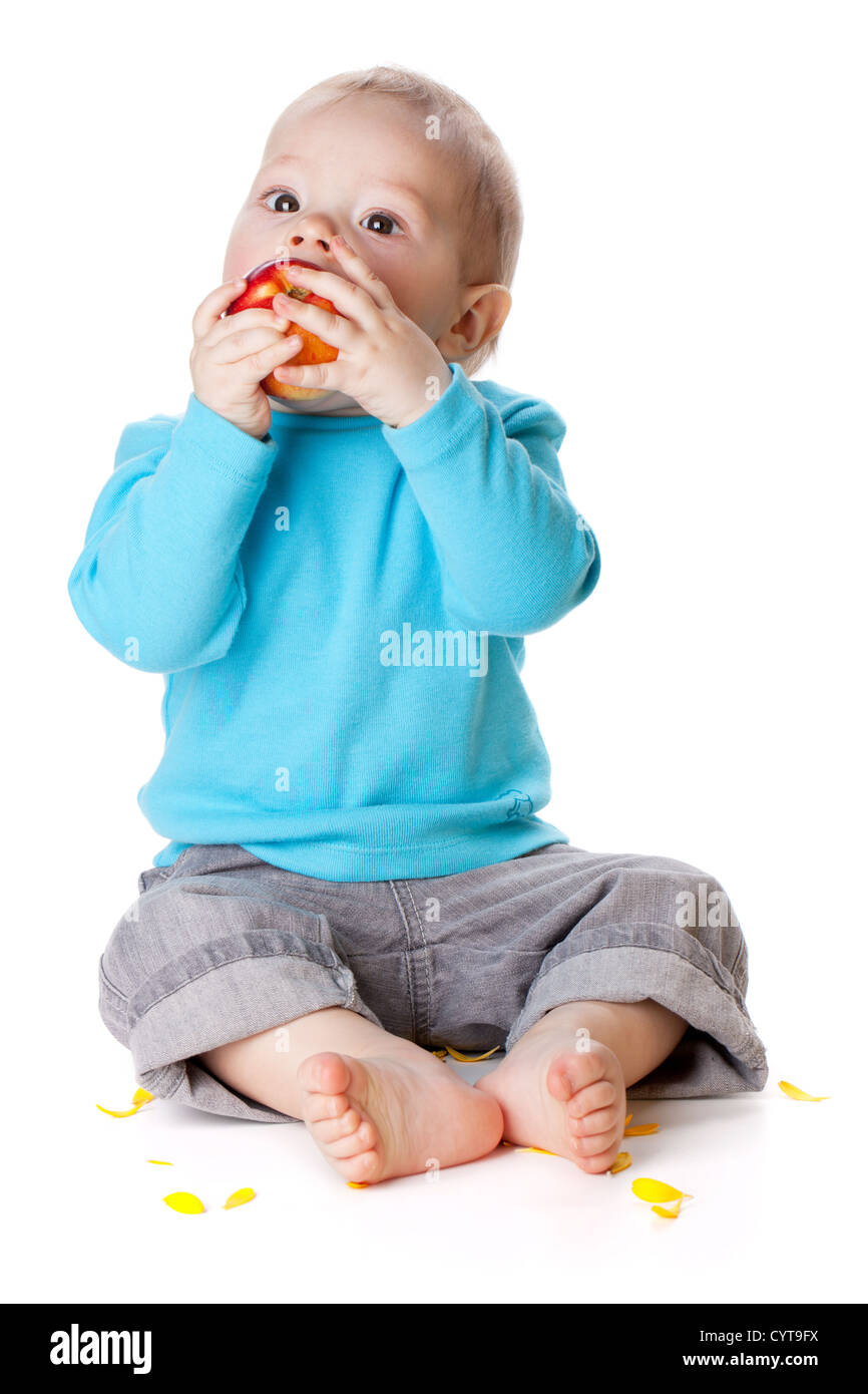 Small baby eating red apple. Isolated on white Stock Photo - Alamy