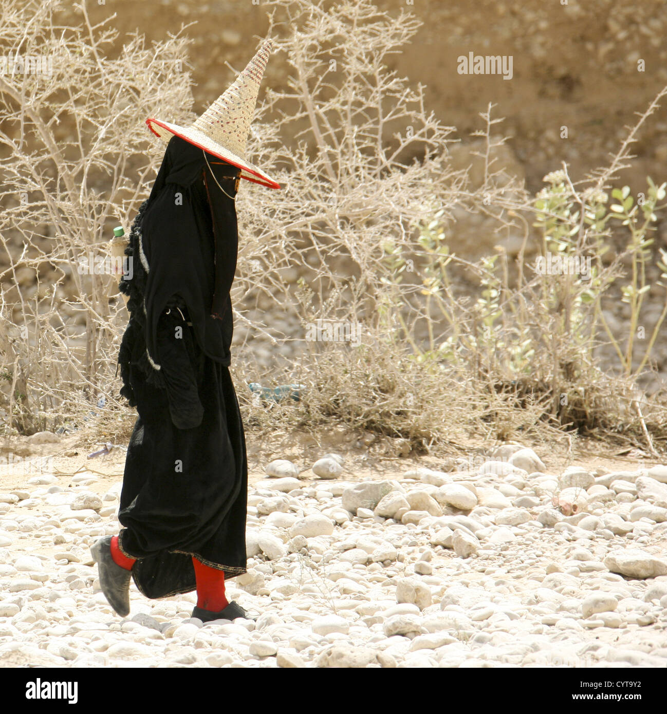 Hadramaut Woman Dressed In Black And Wearing A Cone Hat Passing By ...