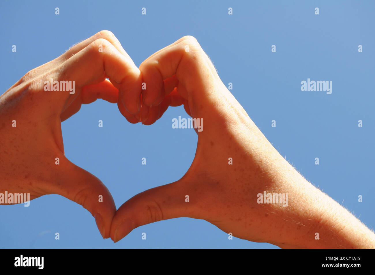 love concept with hand heart and blue sky copyspace Stock Photo - Alamy