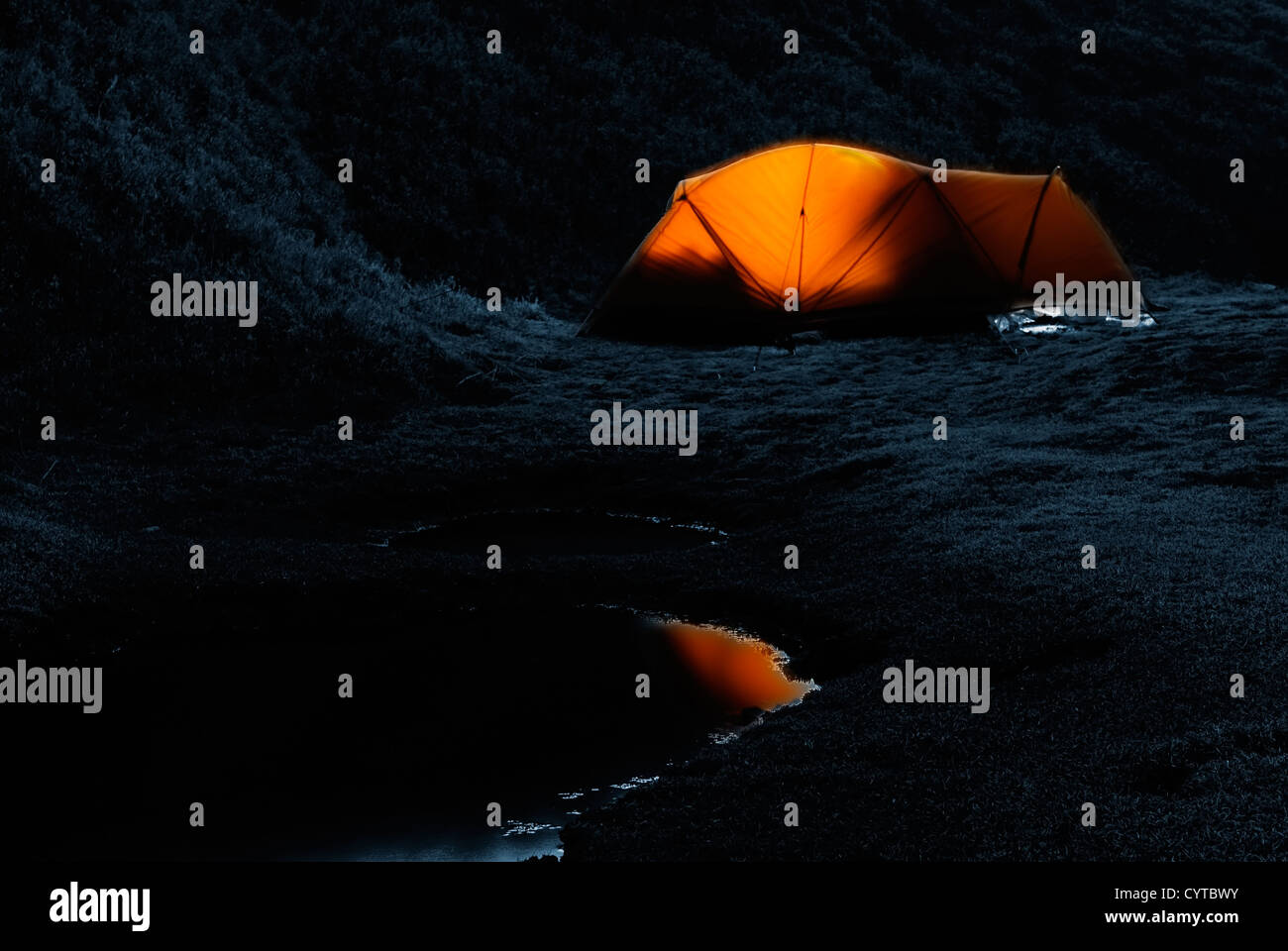 Tent in the night with weak light and small lake Stock Photo - Alamy
