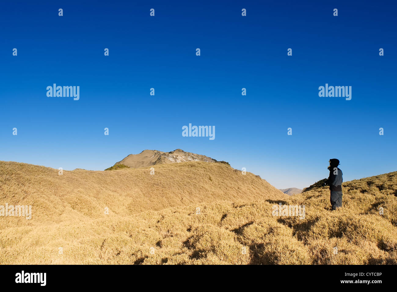 A man stand on the mountain with golden sunshine Stock Photo - Alamy