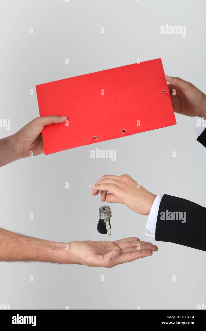 Exchanging keys and a folder Stock Photo - Alamy