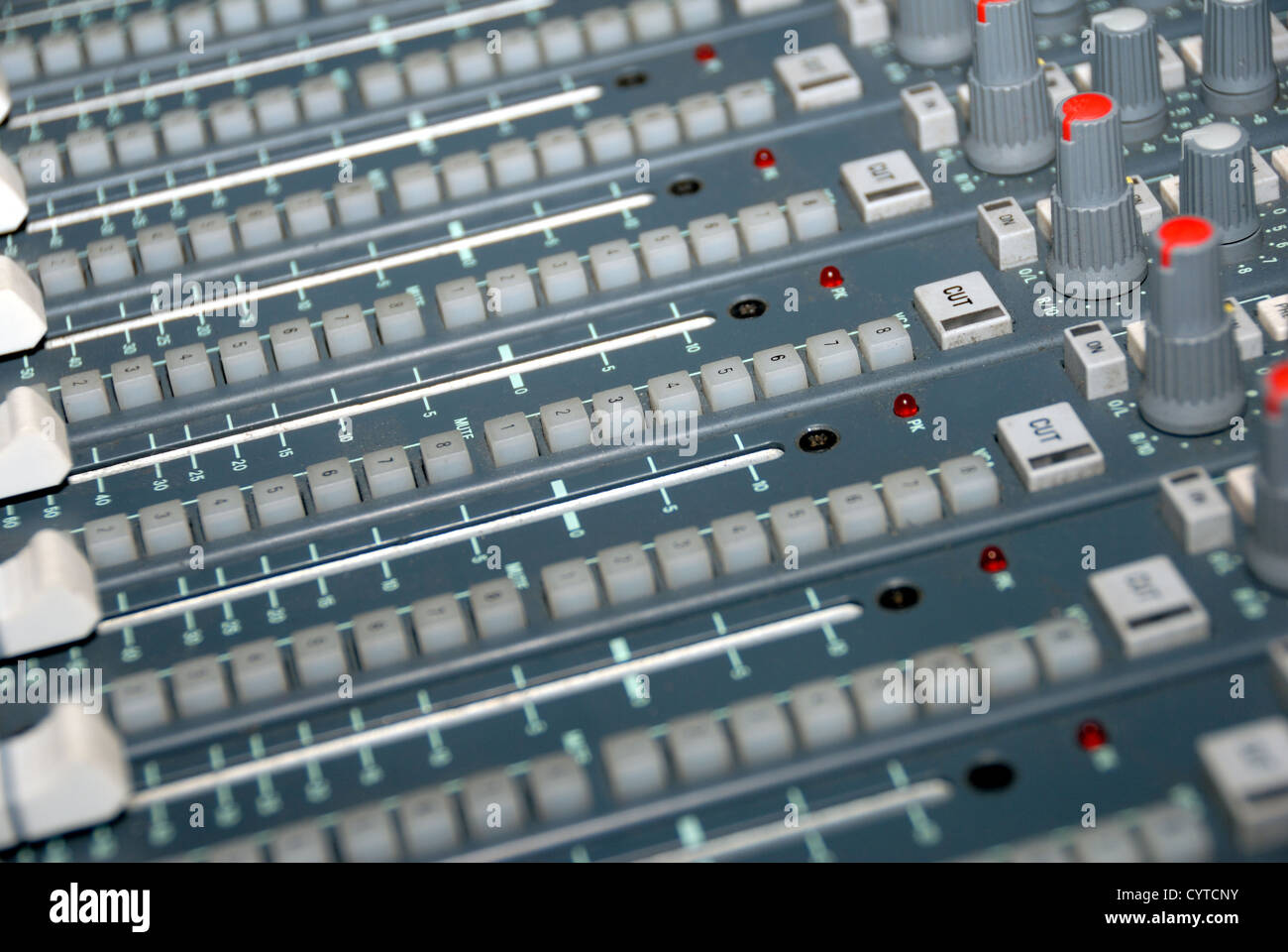 Audio mixing console in a recording studio. Faders and knobs of a sound ...