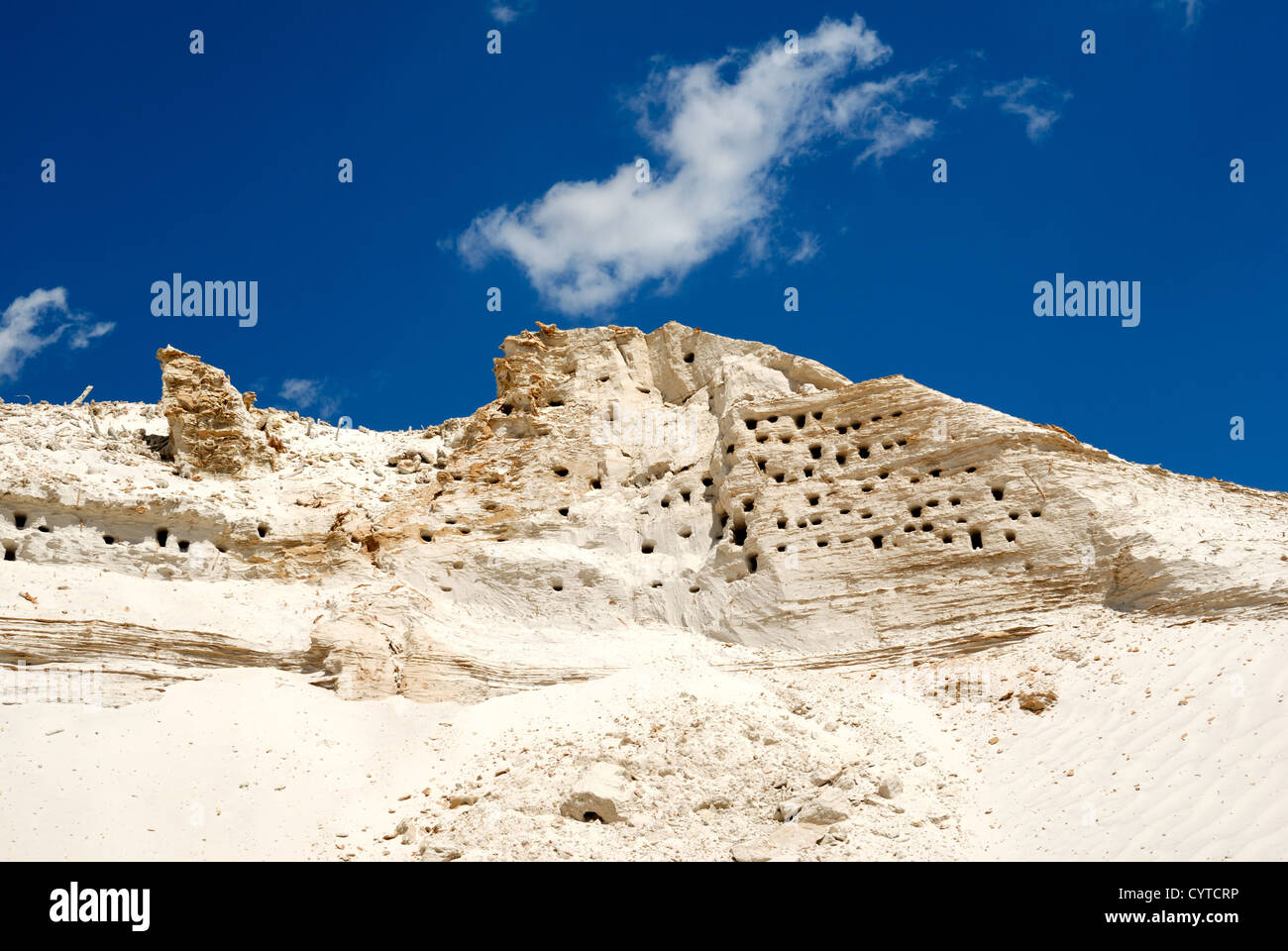 Sandy mountain with the bird's nests against the blue sky Stock Photo ...