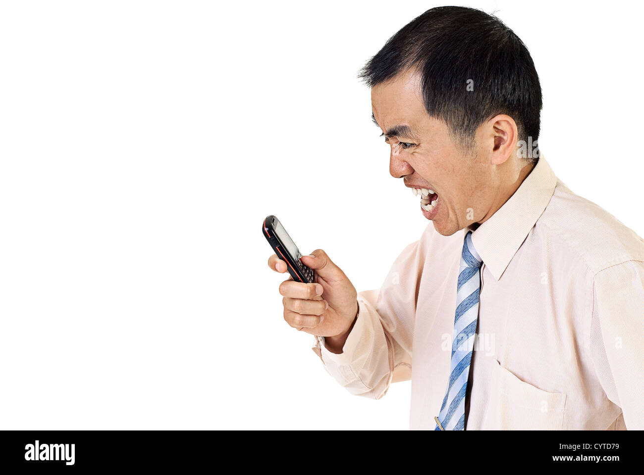 Angry businessman with cellphone on white background Stock Photo - Alamy