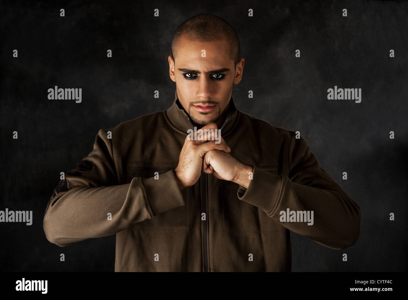 Handsome African Hispanic guy frowning with strong mad macho expression ...