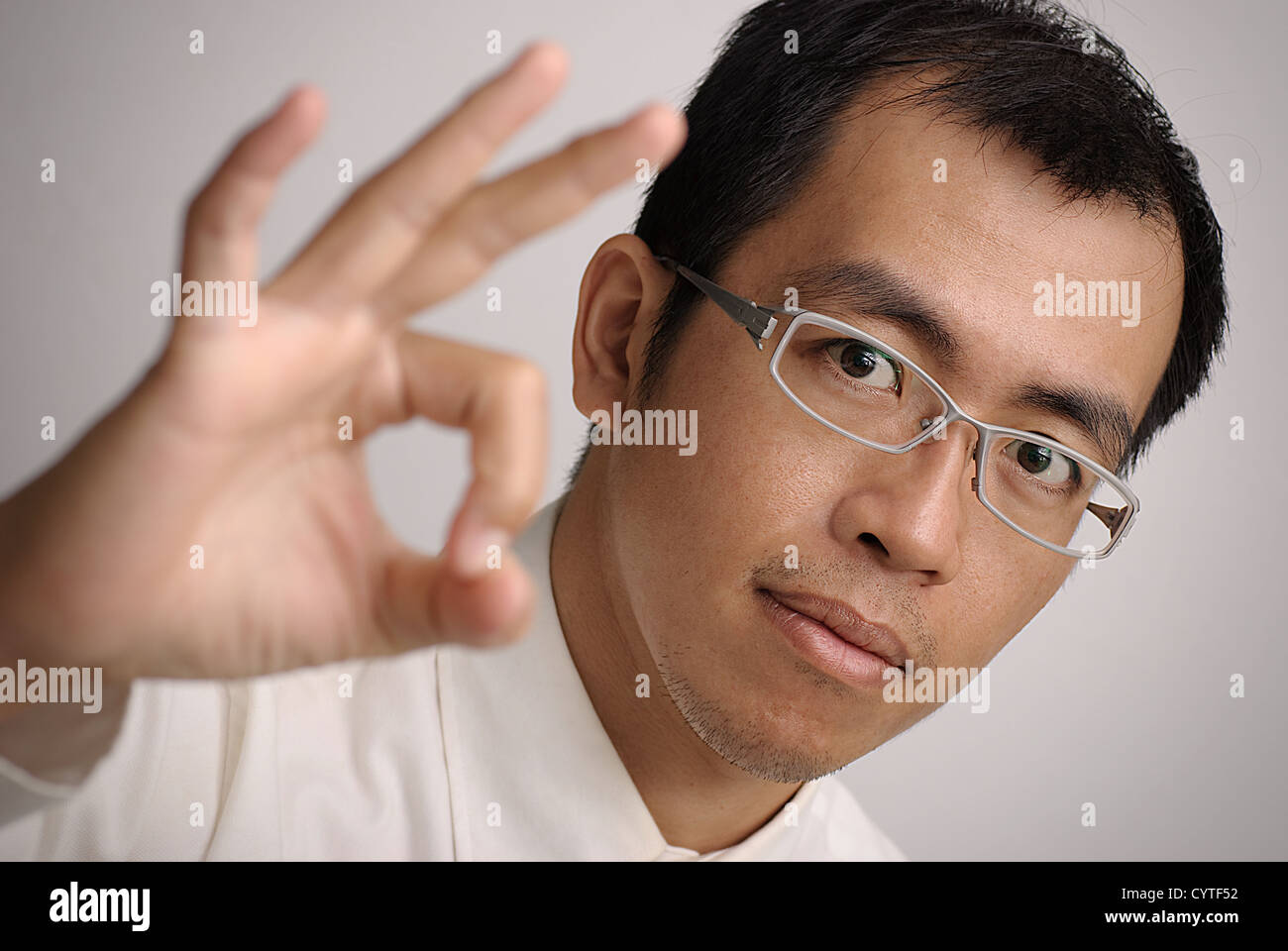 Manager give you a Ok gesture, closeup portrait of Asian business man ...