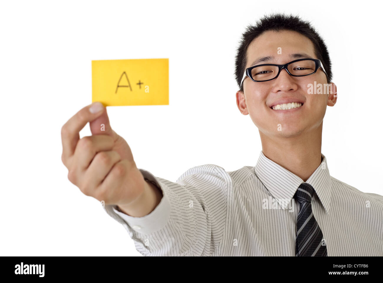 Happy business man holding A+ yellow card and smiling, closeup portrait ...