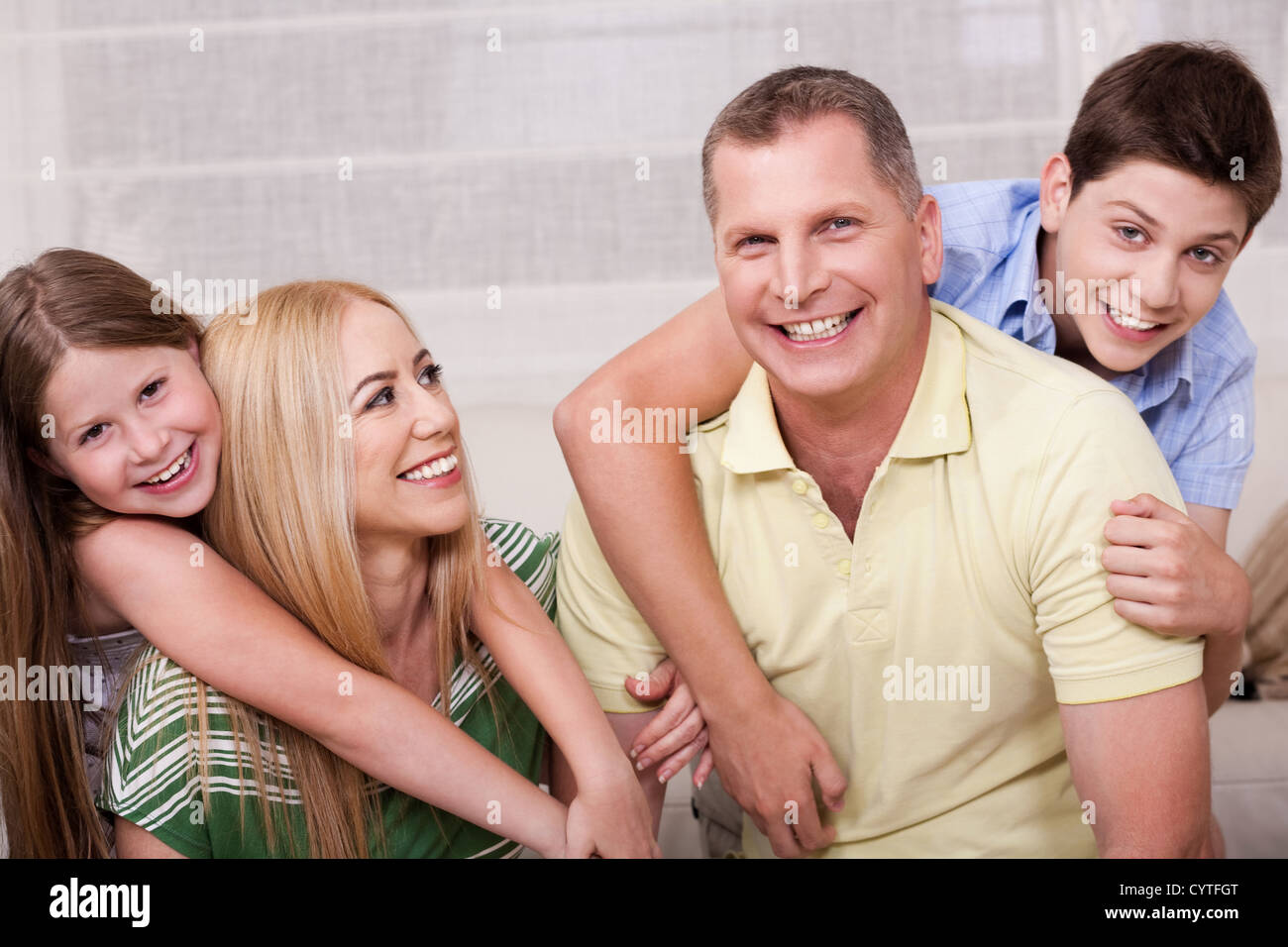 Portrait of lovely family having fun together in living room and ...