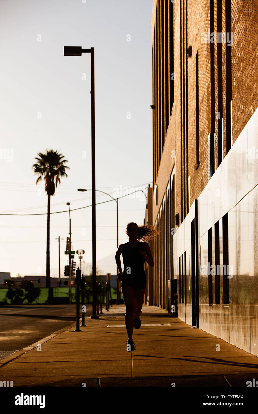 Beautiful woman jogs in the morning sun Stock Photo - Alamy